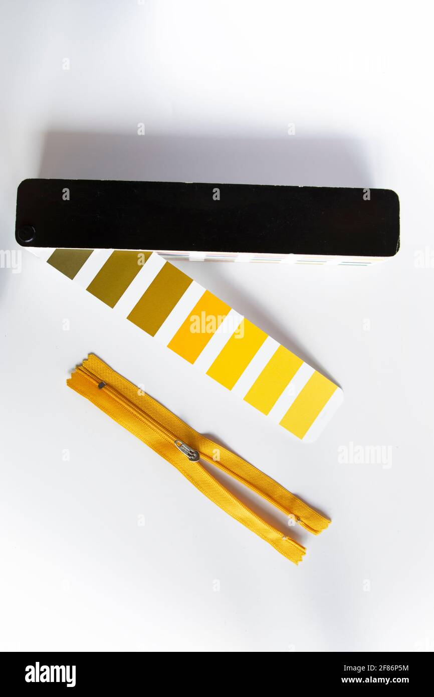 opened color chart and color zipper next to it. yellow one. isolated ...