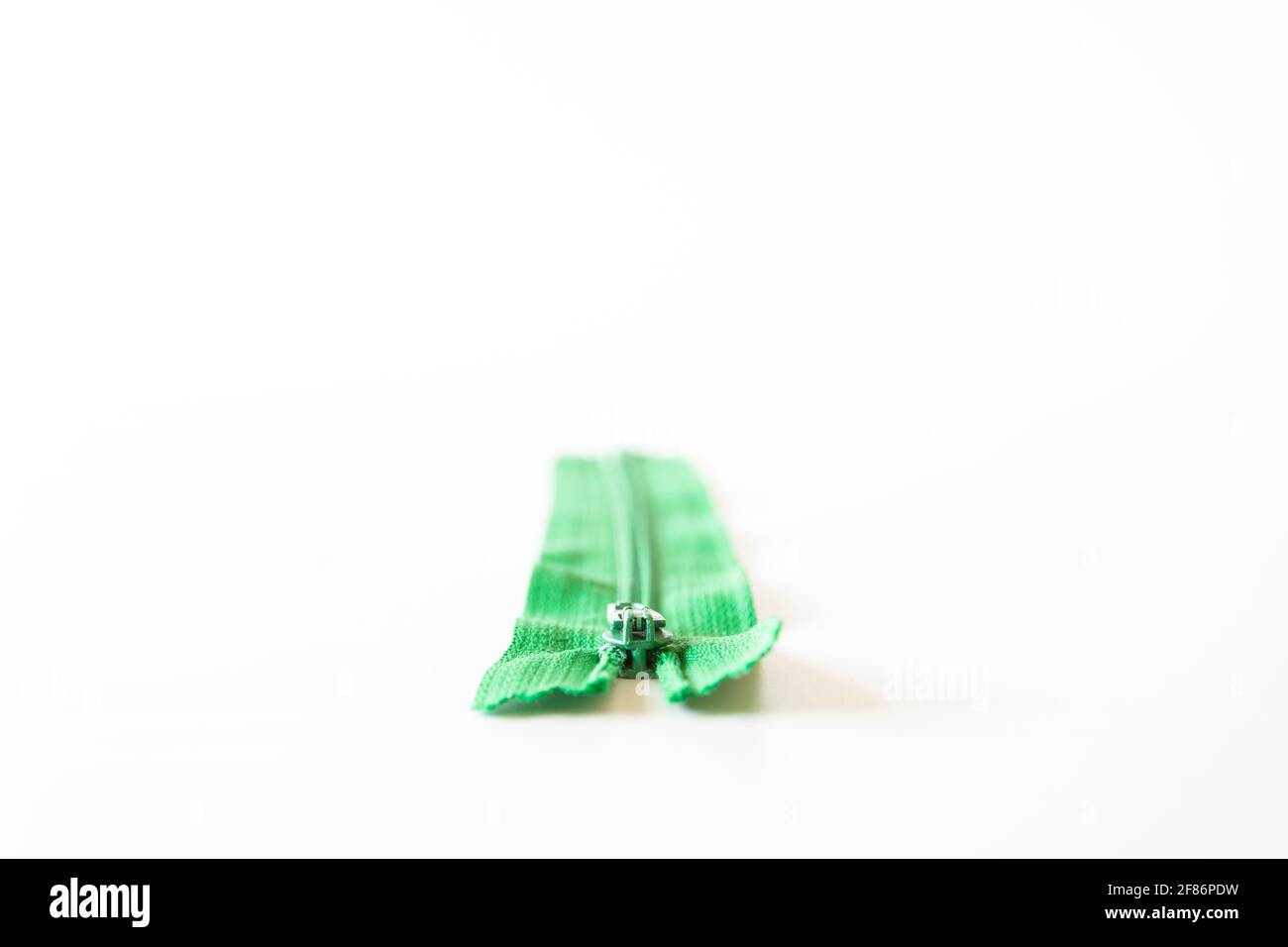 half open Green zipper. Selective Focus. isolated white Background ...