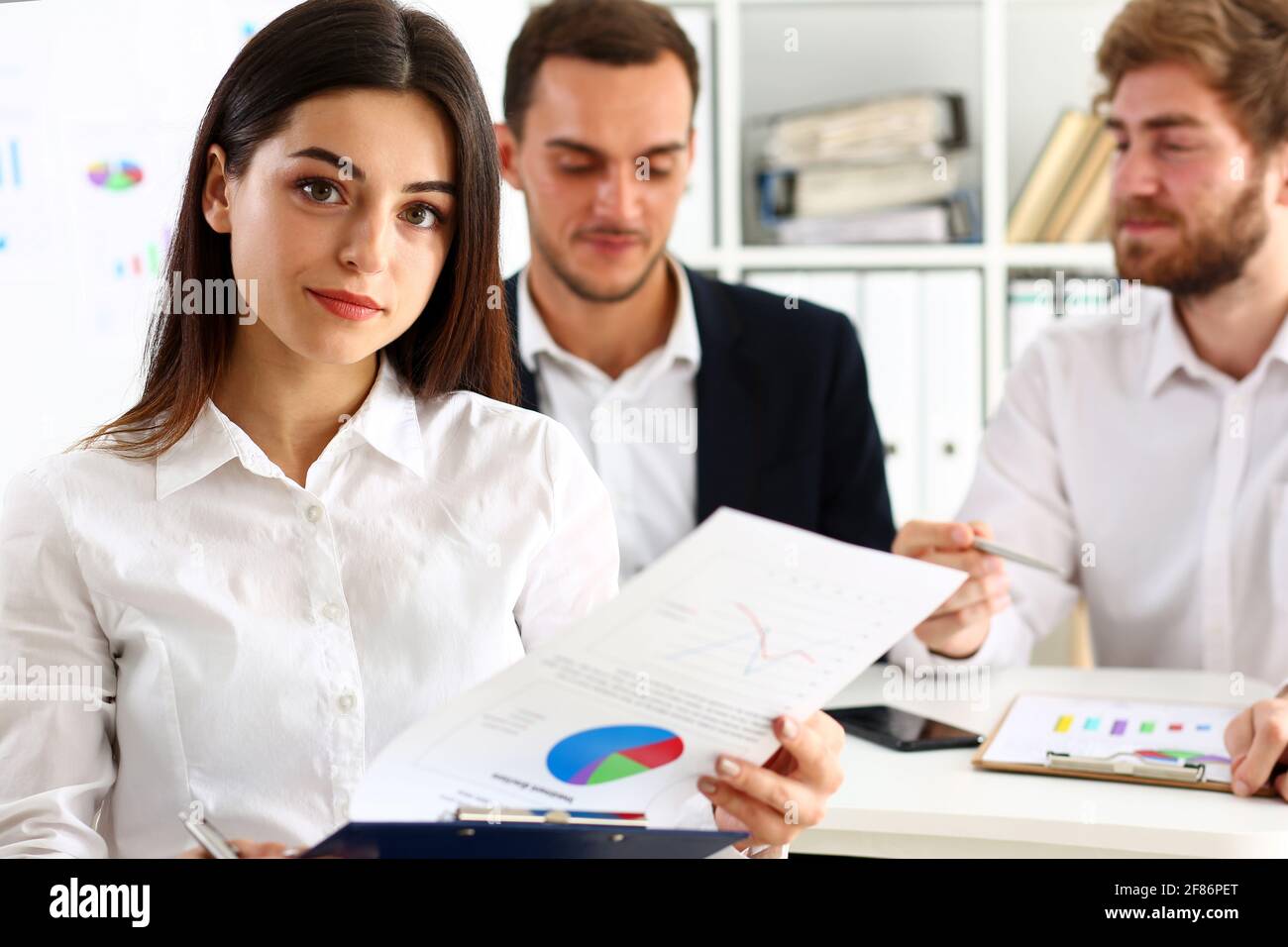 Beautiful smiling cheerful girl at workplace look in camera Stock Photo ...