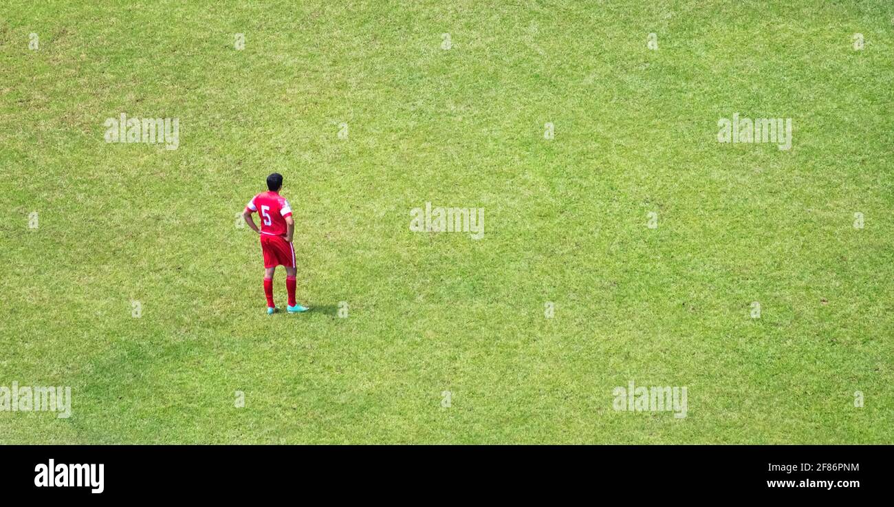 Lonely football player in a football field Stock Photo - Alamy