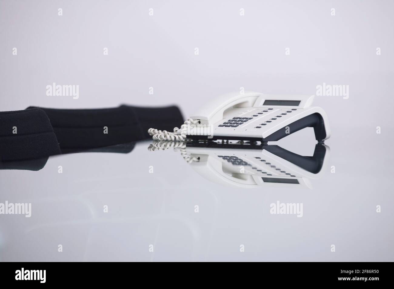 Conference telephone on reflective conference room table Stock Photo ...