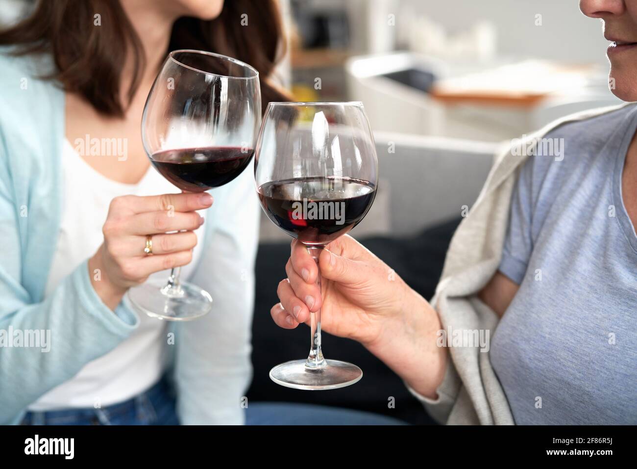 Close up of two women on celebratory toast at home Stock Photo - Alamy