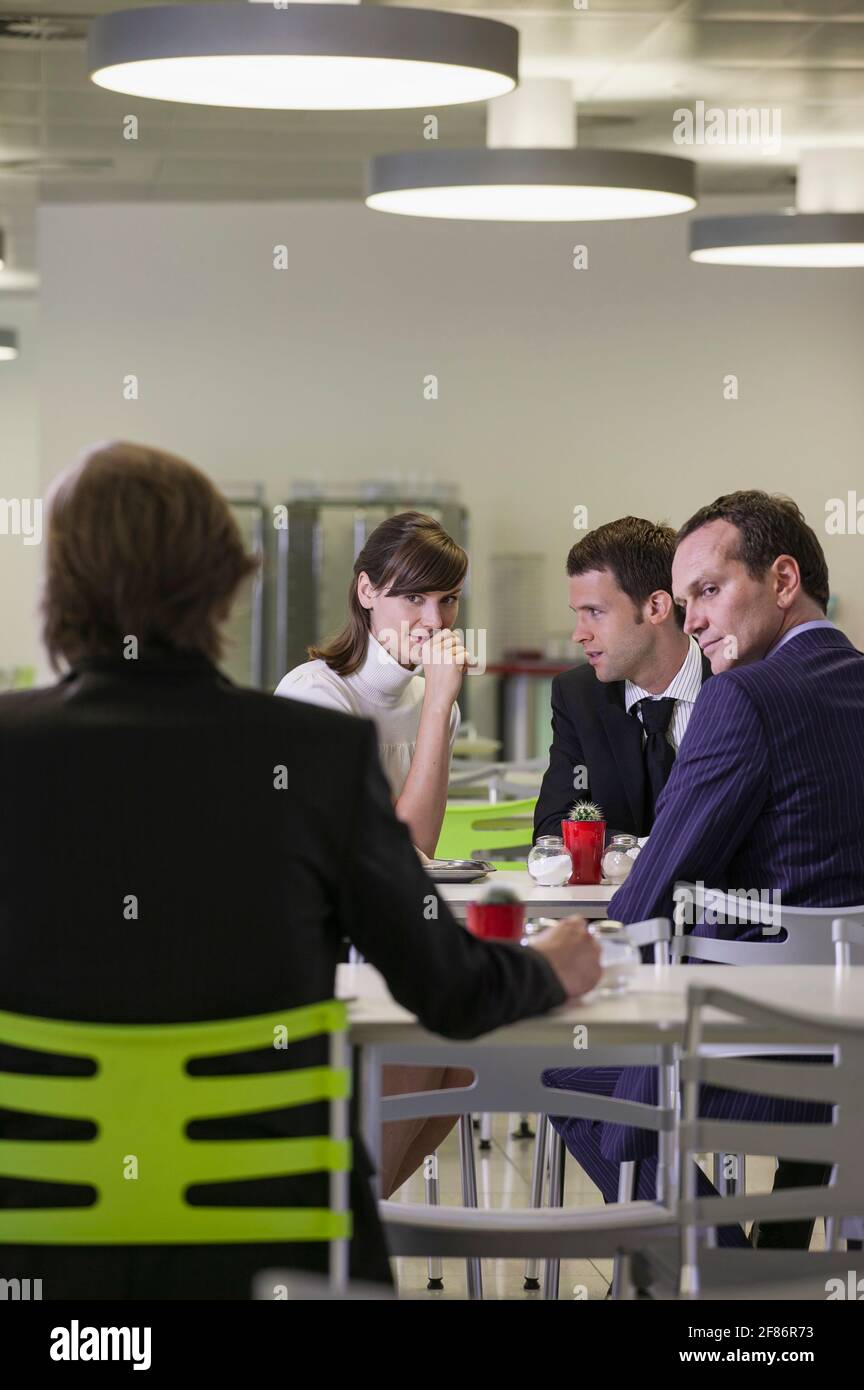 Business people gossiping about colleague in office cafeteria Stock ...