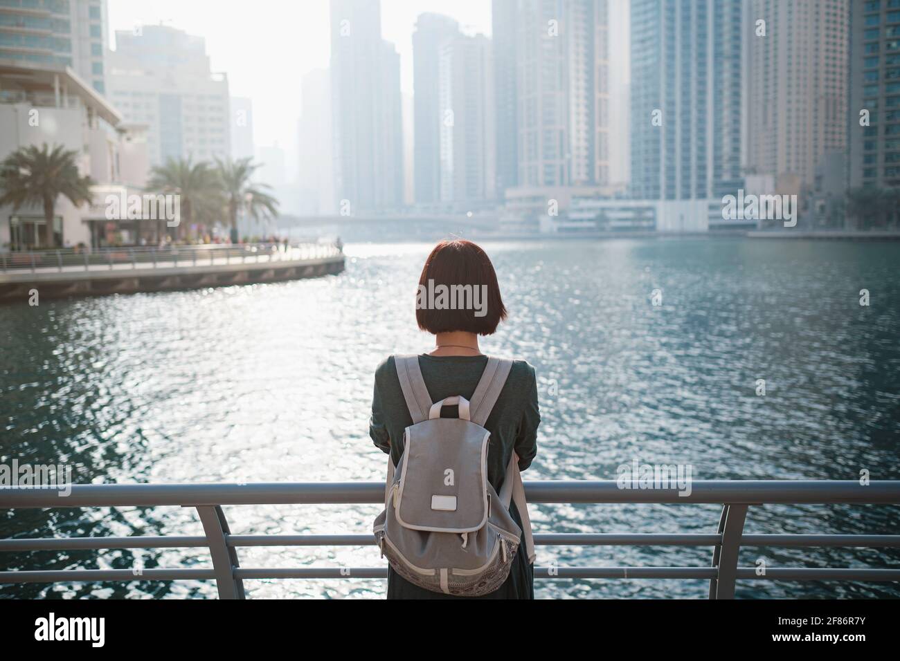 Happy young female traveler in the big city of Dubai, famous place ...