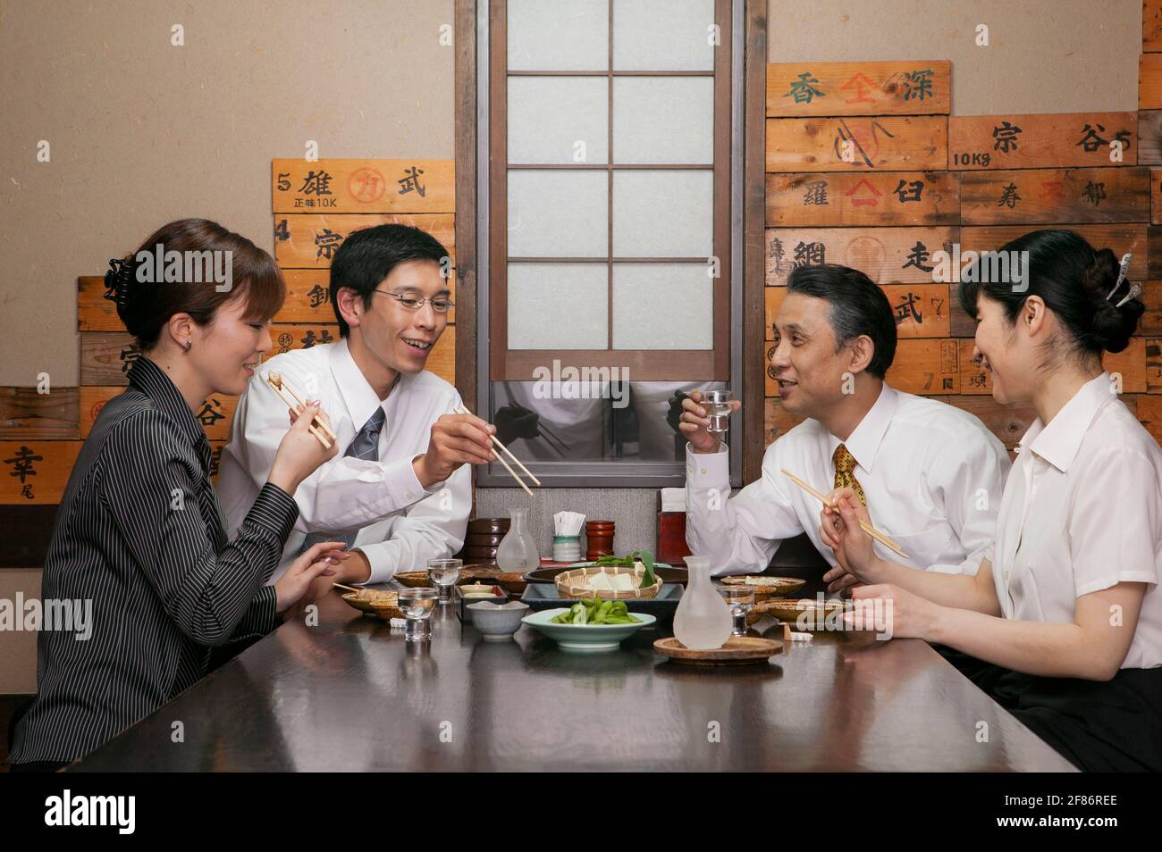 Japanese business people eating lunch at restaurant table Stock Photo ...