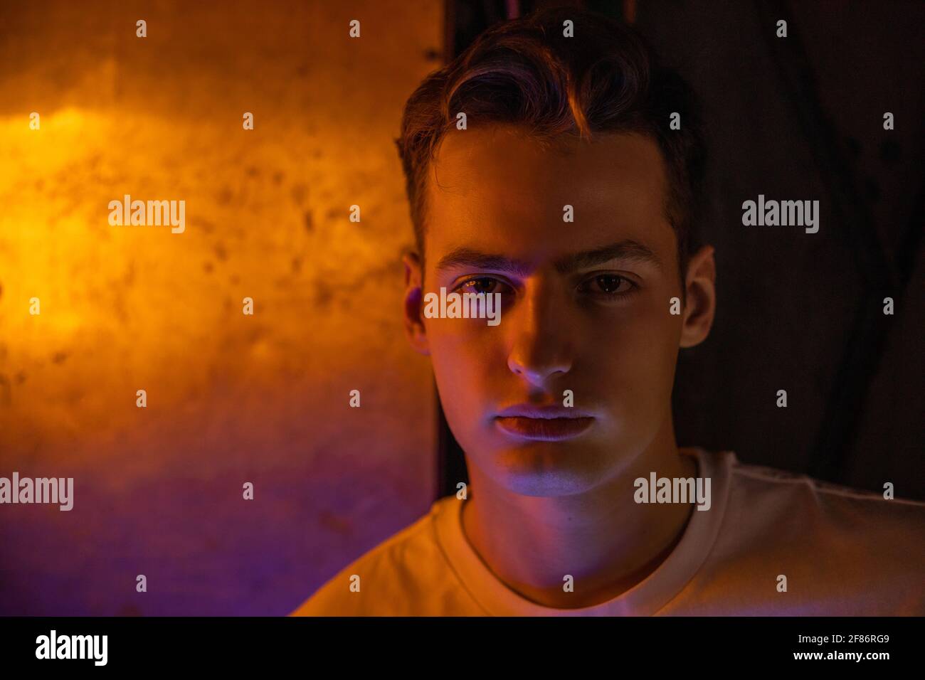 Portrait of attractive young man in neon lighting Stock Photo - Alamy