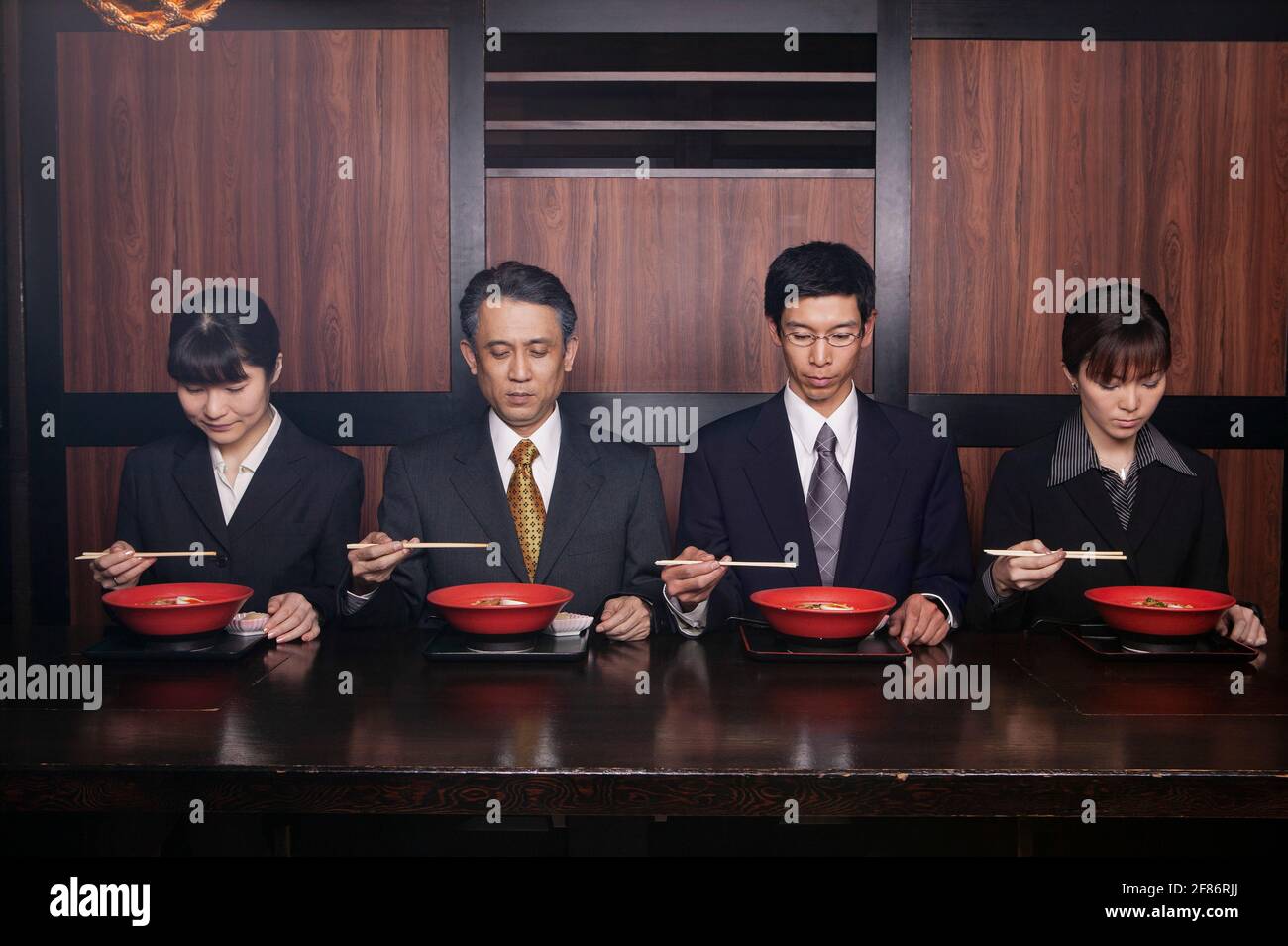 Japanese business people eating with chopsticks in restaurant Stock ...