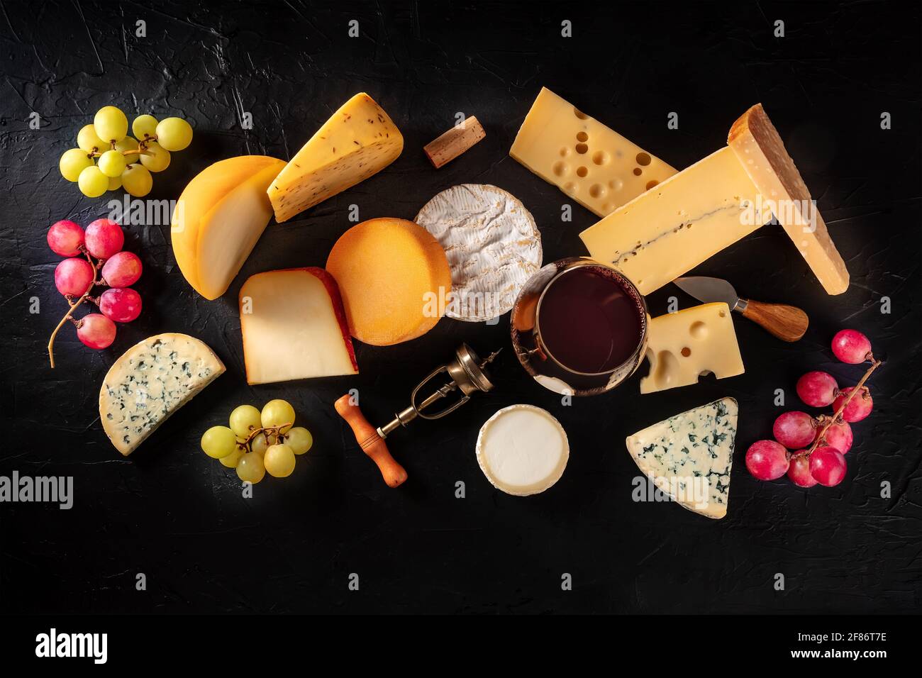 Cheese flat lay. Various cheeses, shot from the top on a black ...