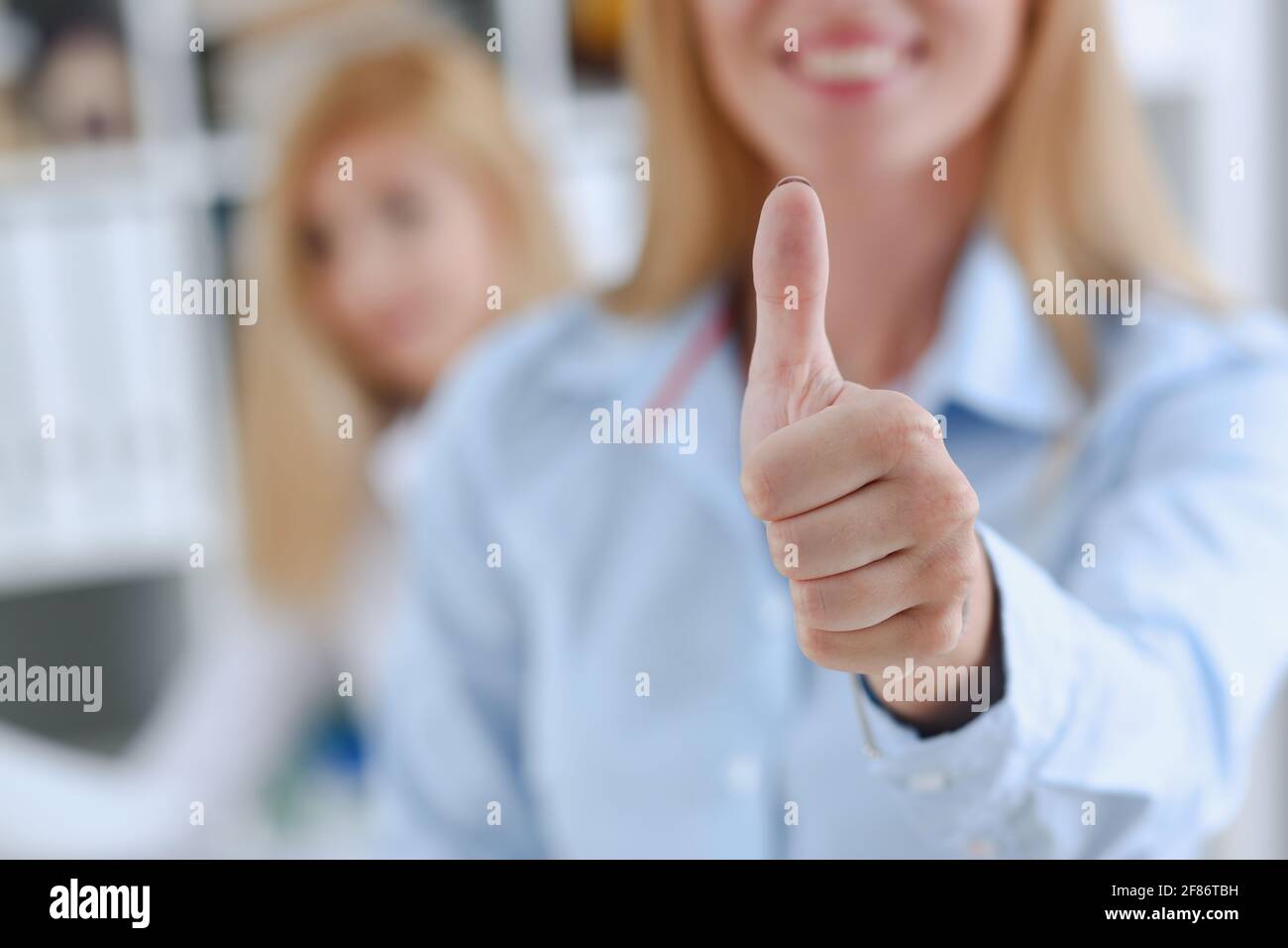 Female arm show OK or approval with thumb up Stock Photo - Alamy