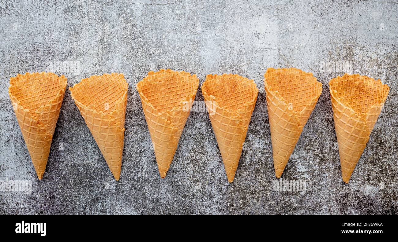 Flat lay ice cream cones collection on dark stone background . Blank ...