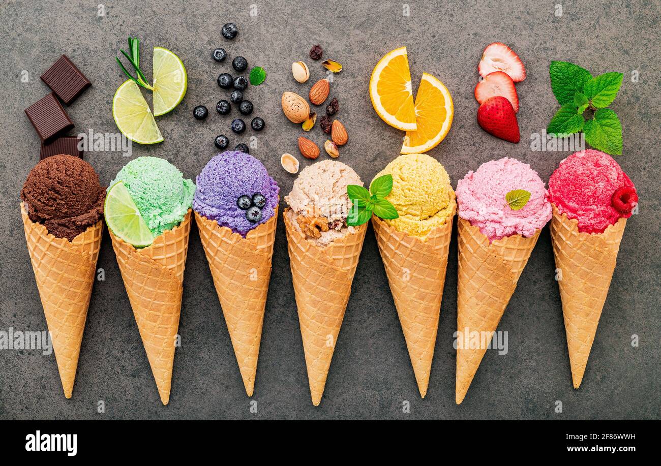 Flat lay ice cream cones collection on dark stone background . Blank ...