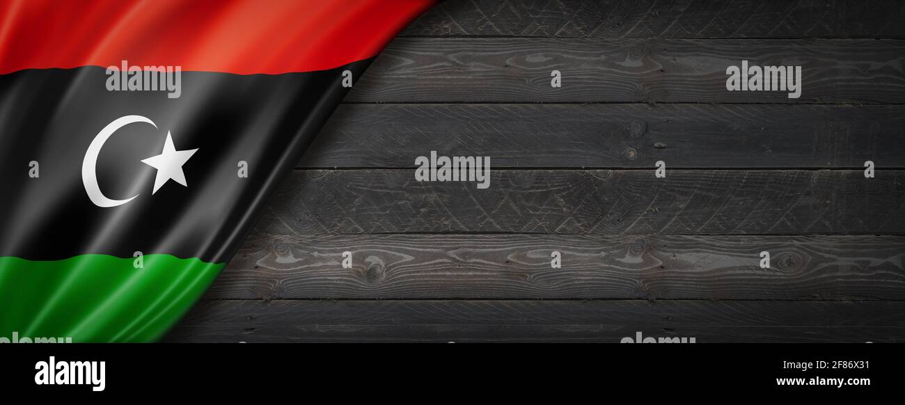 Libya flag on black wood wall. Horizontal panoramic banner Stock Photo ...