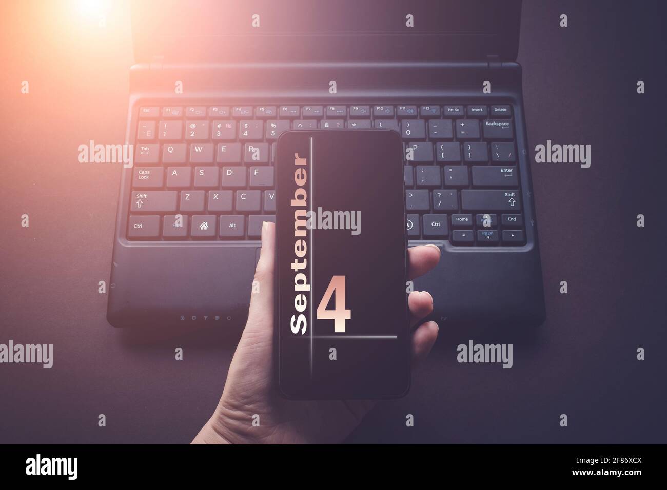 September 4th. Day 4 of month, Calendar date. Hand Holding Mobile Phone ...