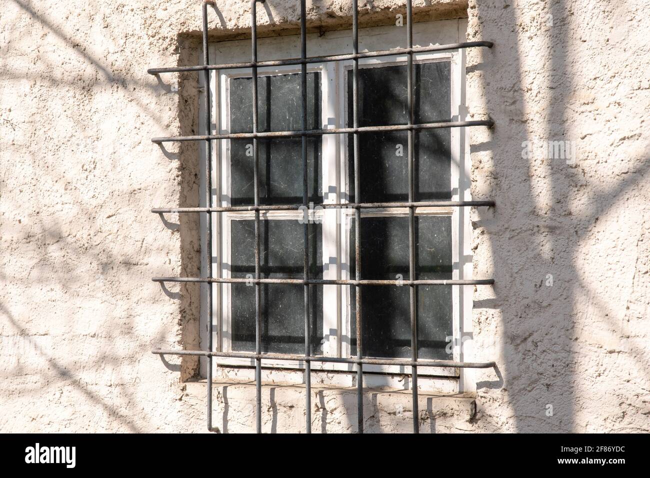 Barred window on a house wall Stock Photo - Alamy