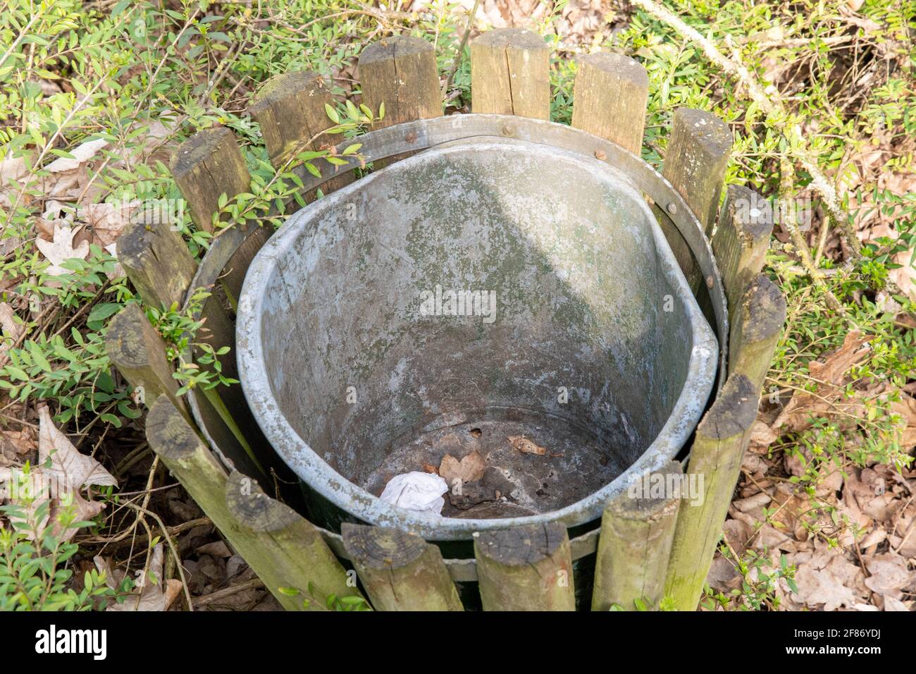 Old dirty and rusty trash can on the side of the road Stock Photo - Alamy