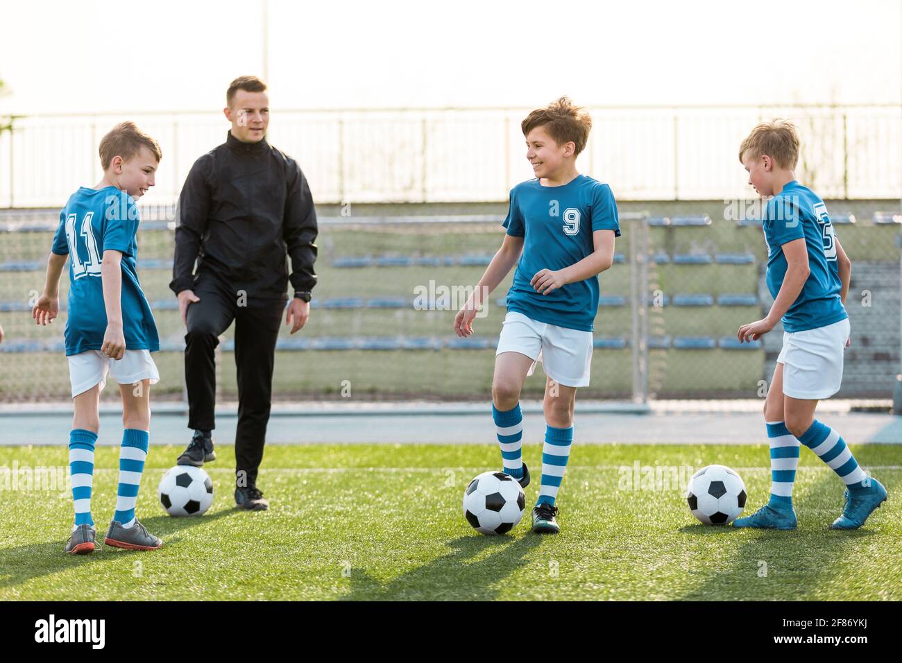 Happy soccer kids smiling on training. Group of school boys practicing ...