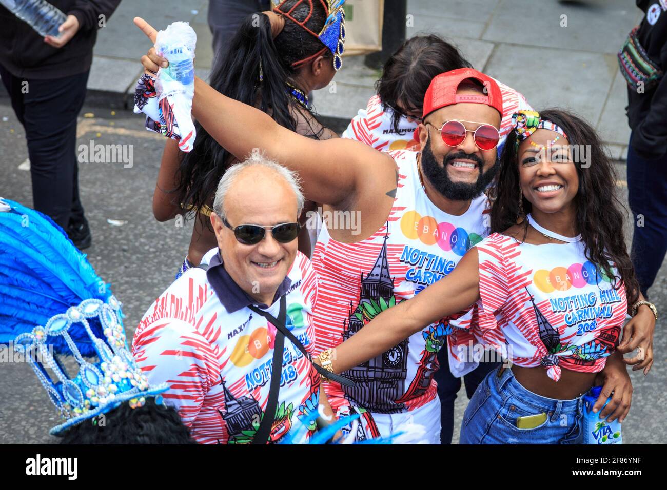 Revellers smile and wave, having fun at Notting Hill Carnival, London ...