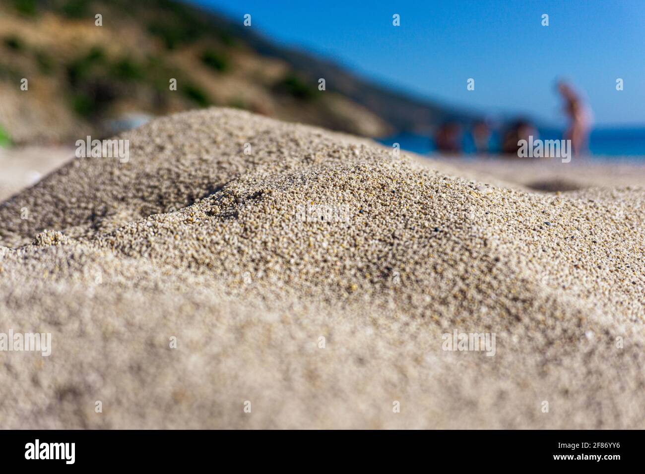 Sand puddle. view of people on the beach from the dune Stock Photo - Alamy