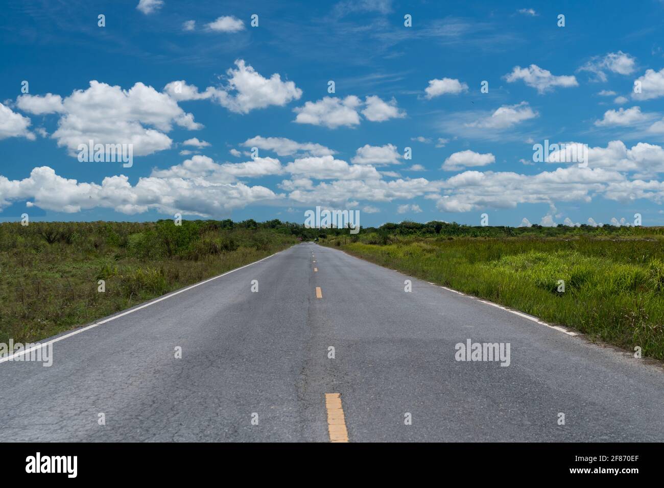 Small country road or street with blue sky background Stock Photo - Alamy
