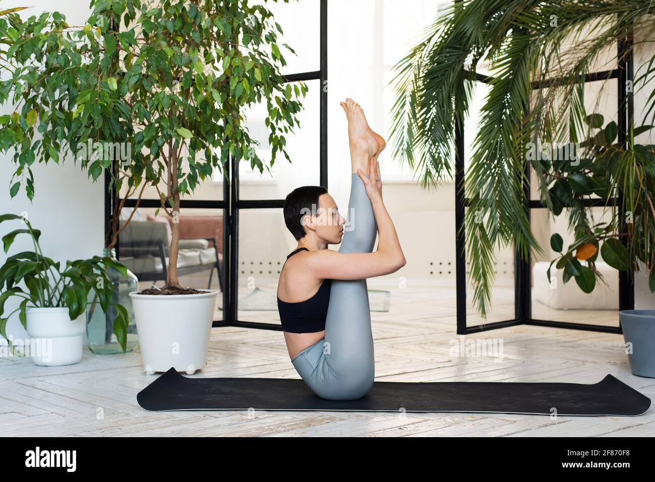 Female yoga teacher practicing in studio. Woman doing exercise in ...