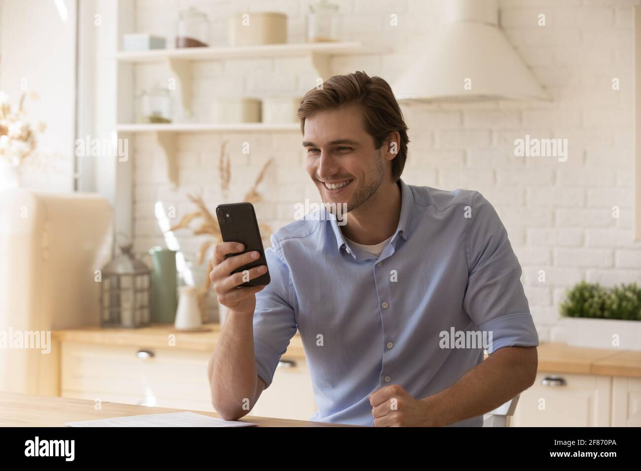 Close up overjoyed man looking at phone screen, having fun Stock Photo ...