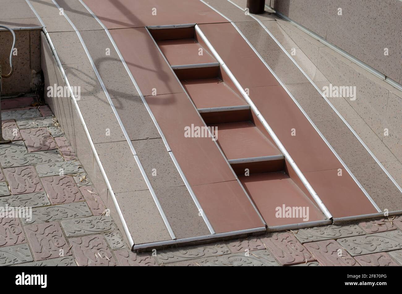 Brown and beige ramp for the disabled with steps. Entrance to the ...
