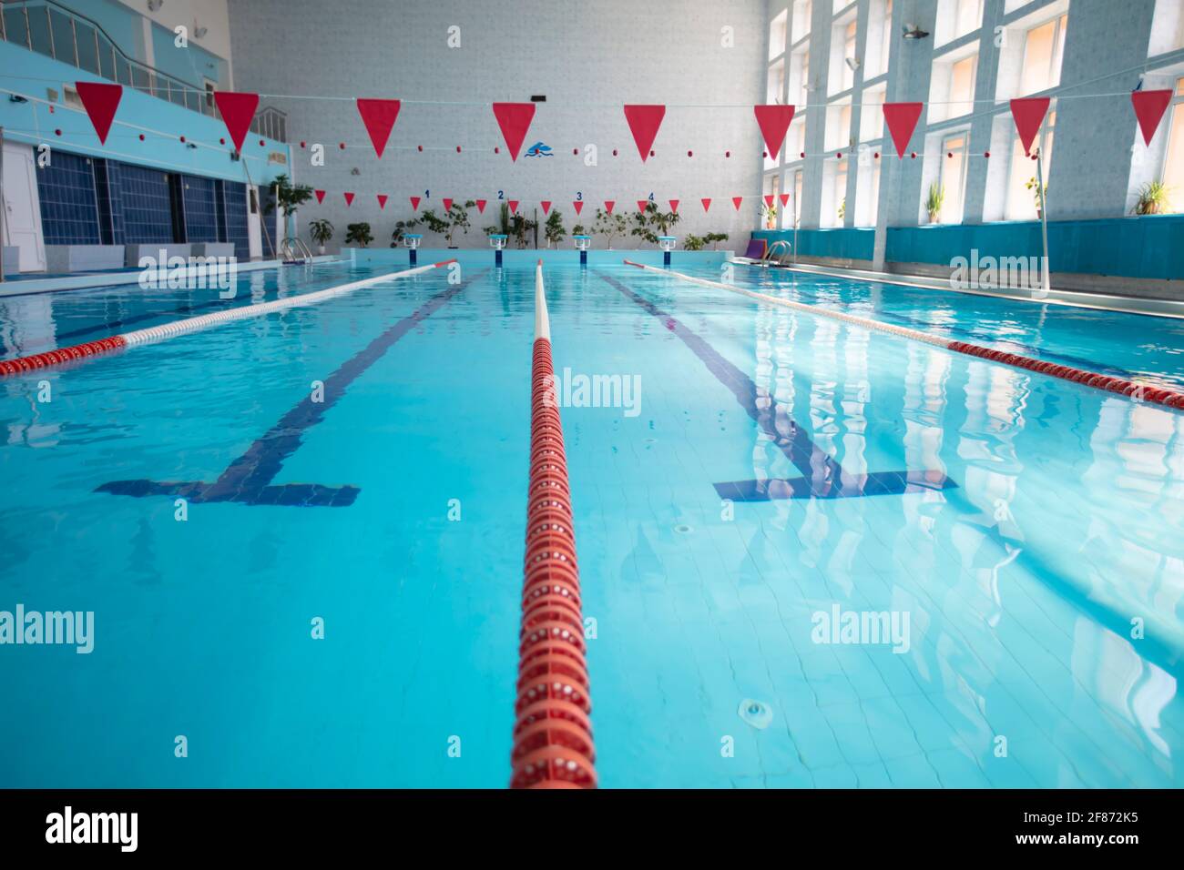 An empty sports pool with a red dividing path. Blue water in the ...