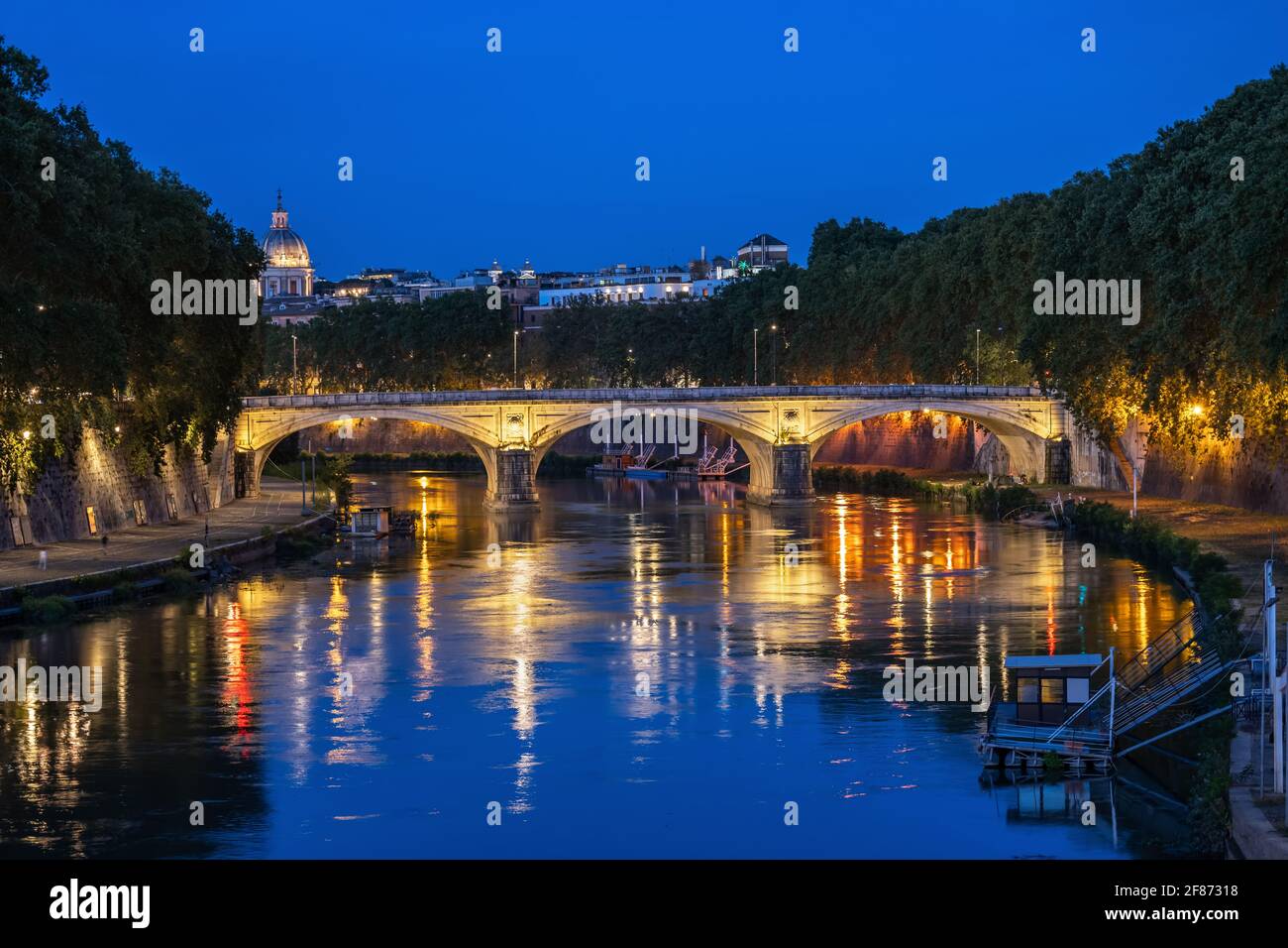 Ponte Umberto I bridge over Tiber river at night in city of Rome in ...