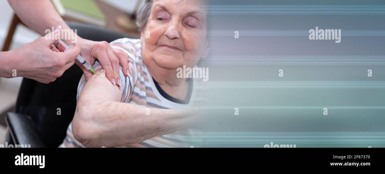 Nurse giving an injection to senior woman; panoramic banner Stock Photo ...
