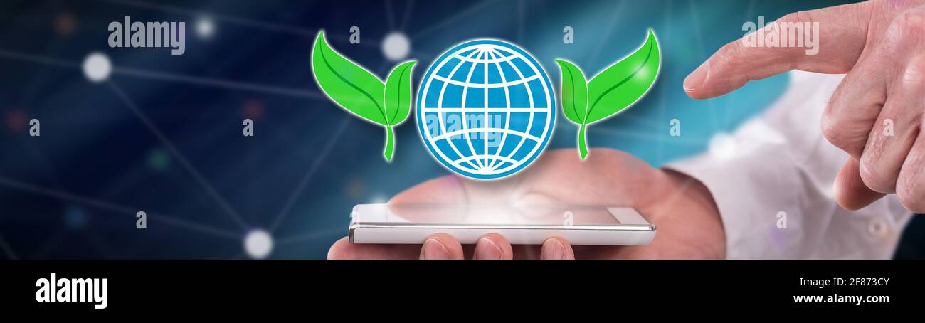 Ecology concept above a smartphone held by a man Stock Photo - Alamy