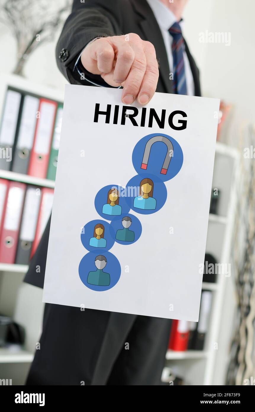 Paper showing hiring concept held by a businessman Stock Photo - Alamy