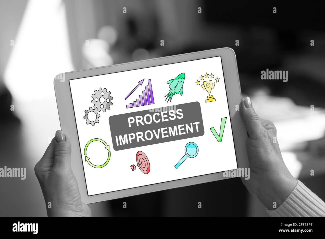 Process improvement concept shown on a tablet held by a woman Stock ...