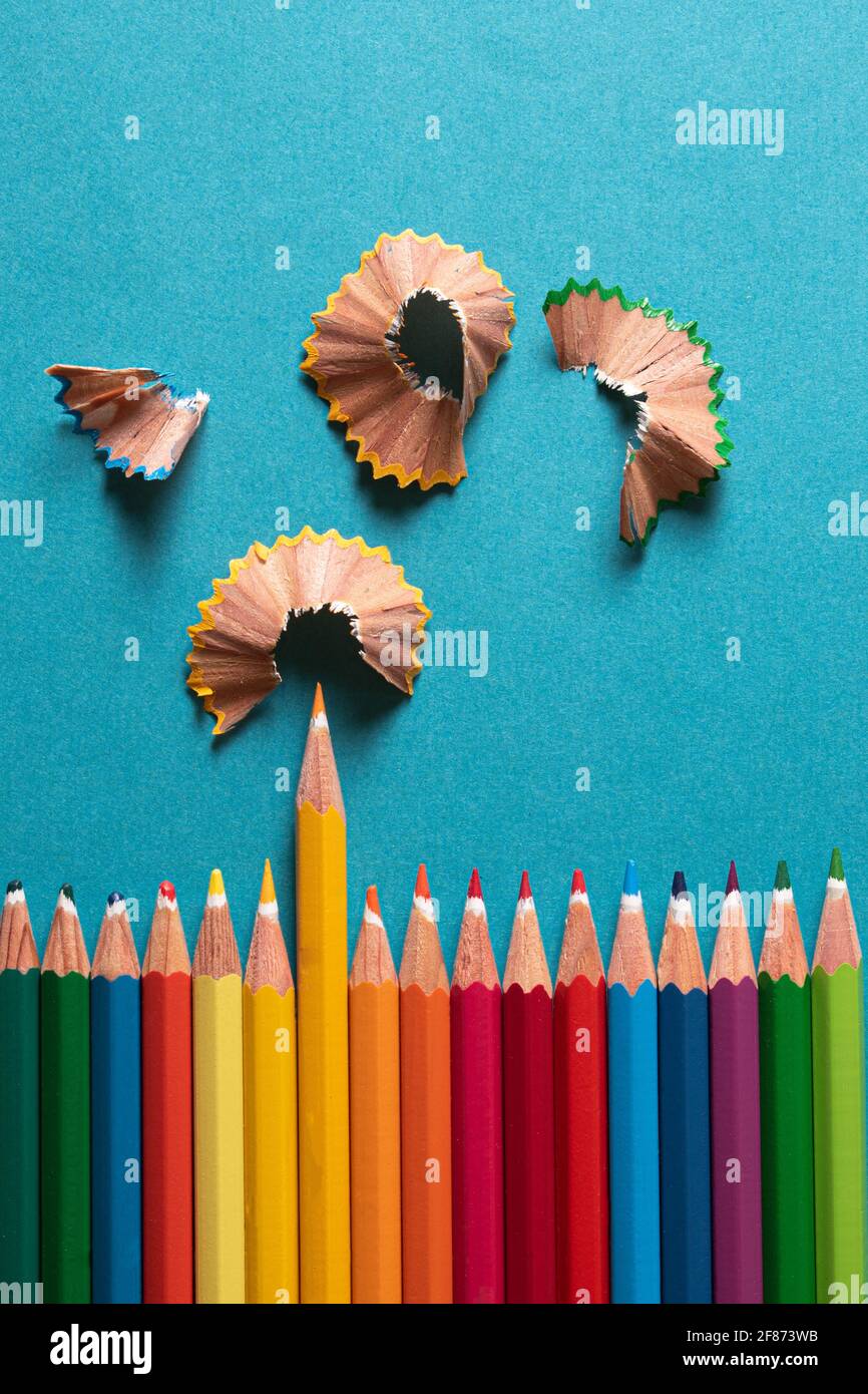 Top view. Colored pencils side by side with pencil shavings on top. All ...