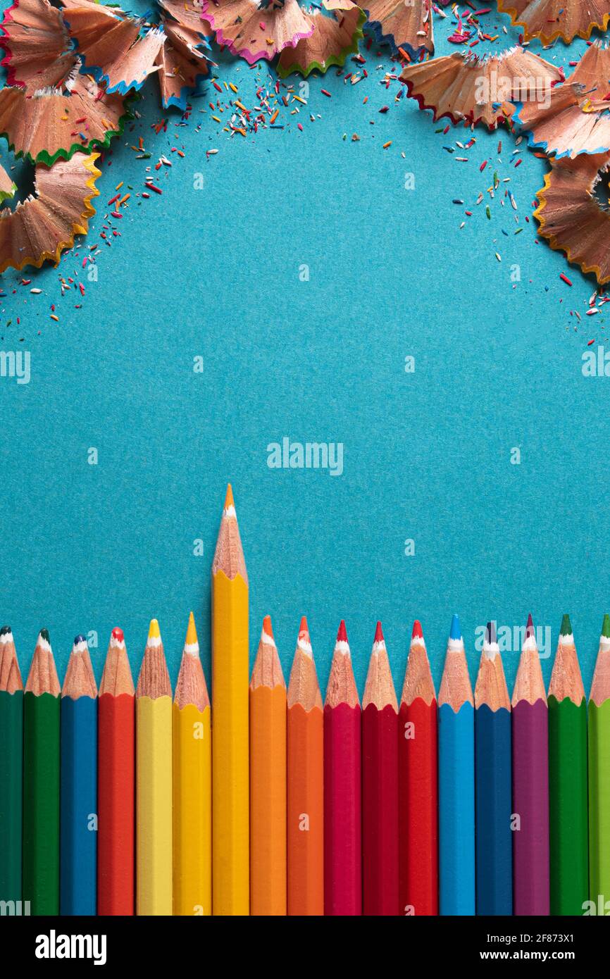 Top view. Colored pencils side by side with the yellow pencil pointing ...
