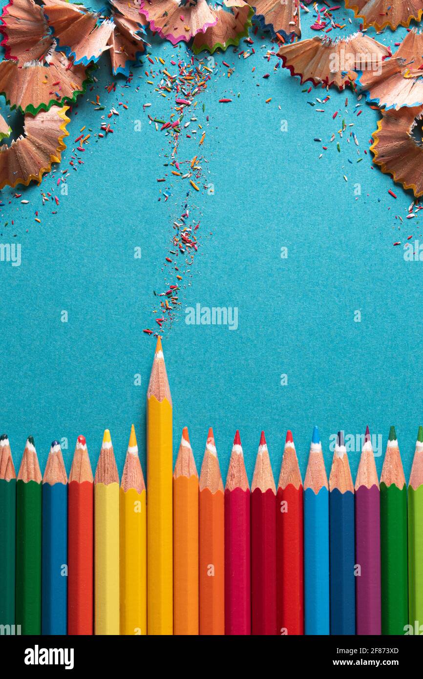 Top view. Colored pencils side by side with the yellow pencil pointing ...