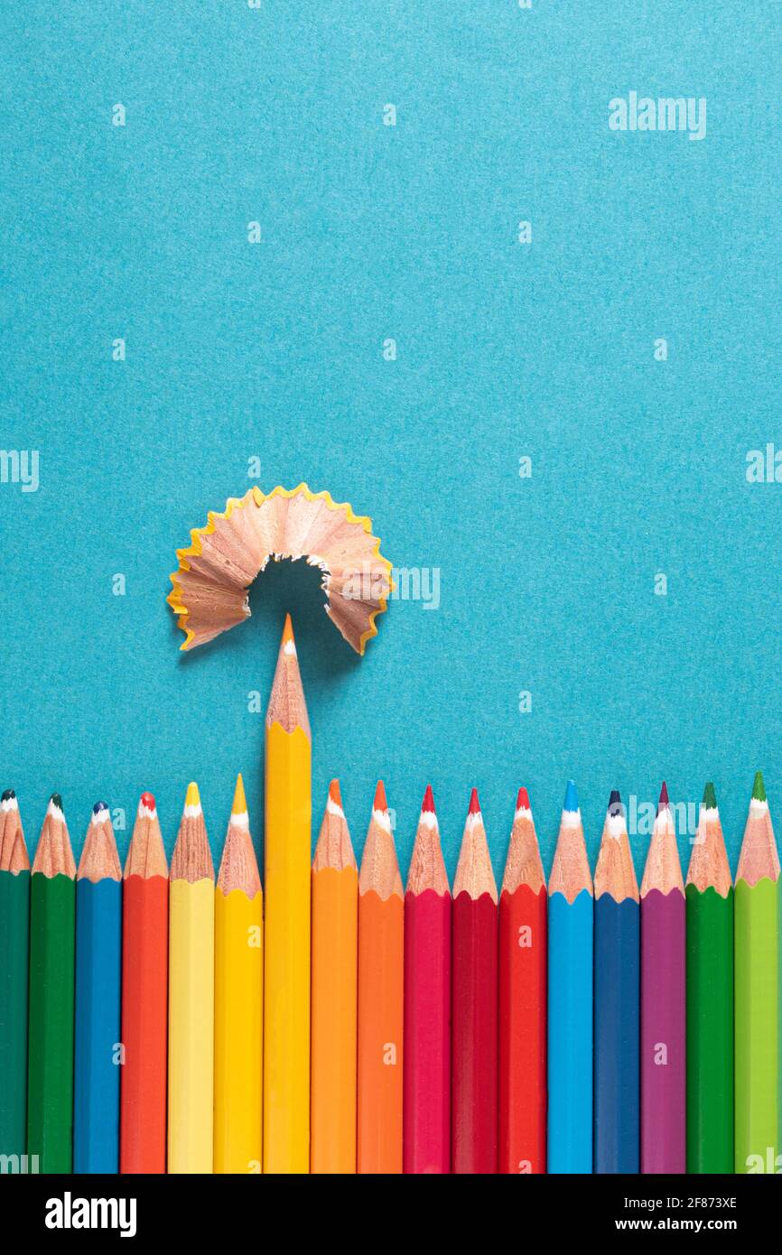 Top view. Colored pencils side by side with a pencil shaving on top ...