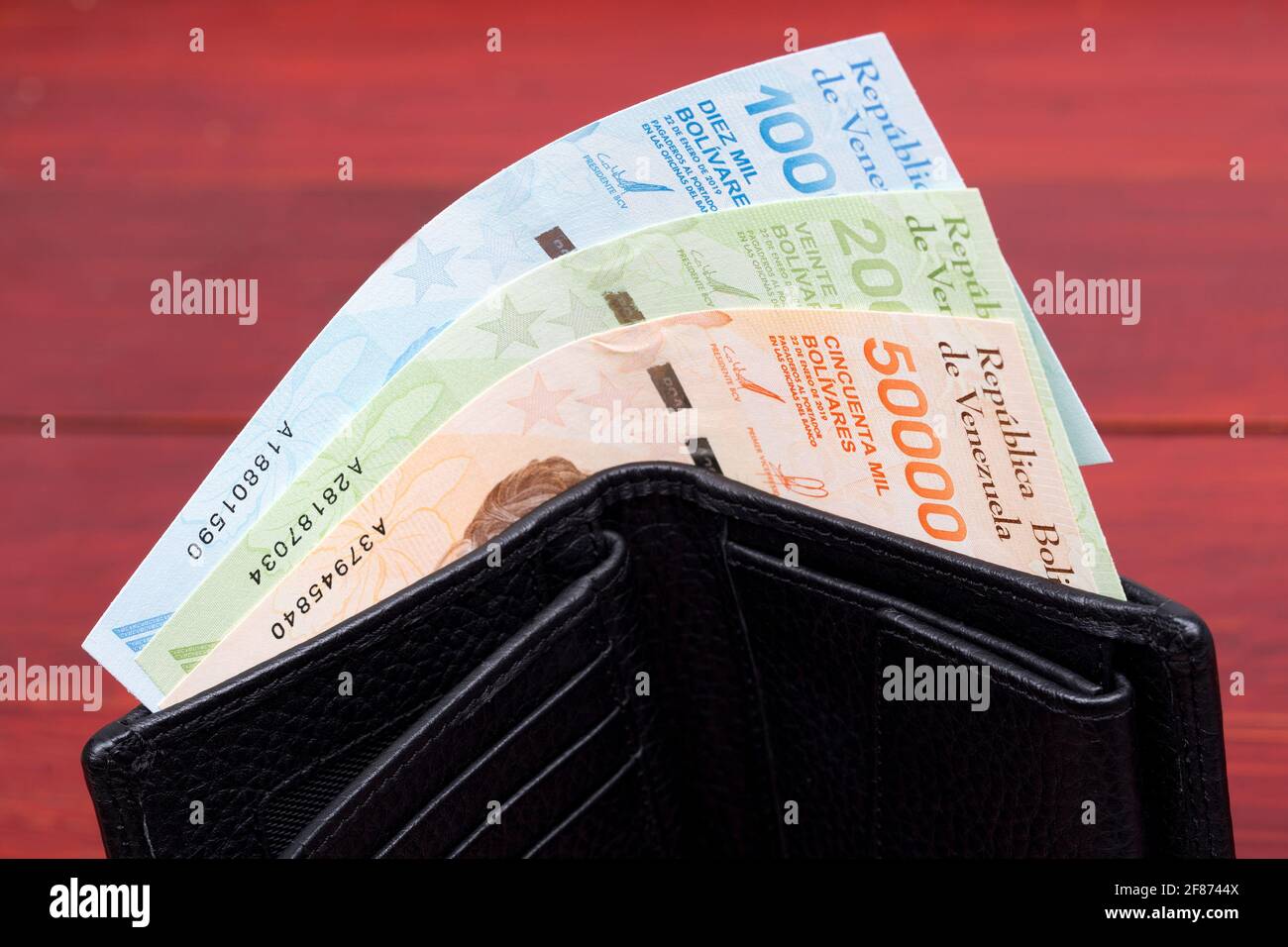 Venezuelan money in the black wallet Stock Photo - Alamy