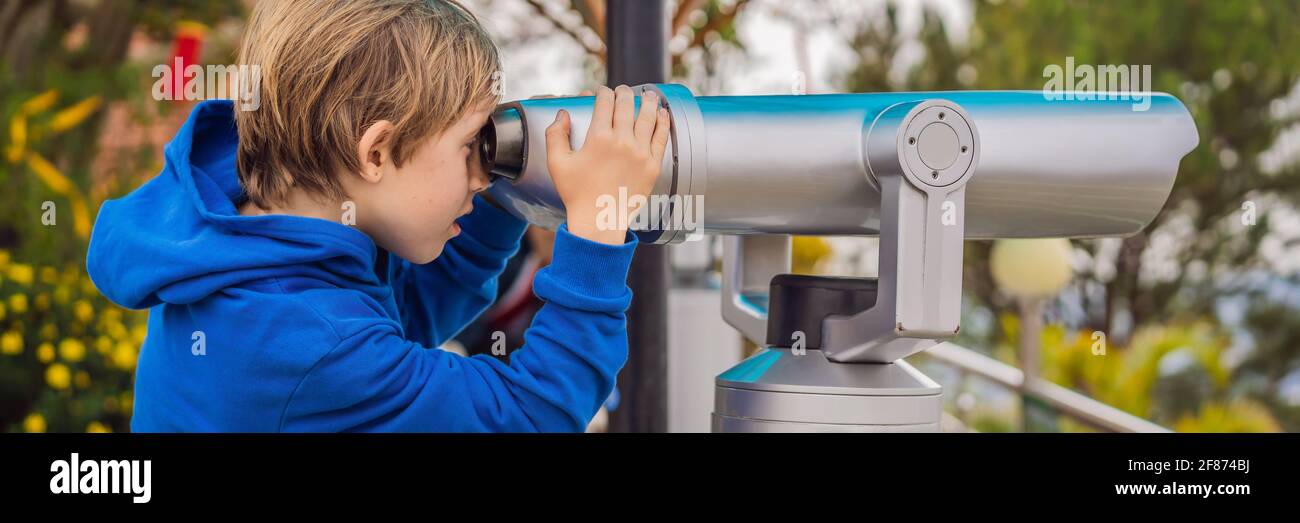 Binoscope. Stationary city binoculars. A boy looks at the city through ...