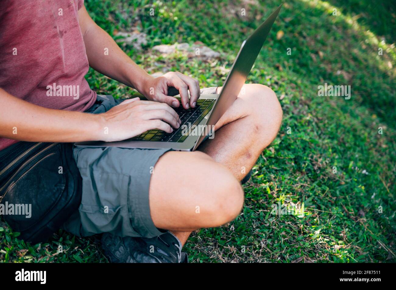 Digital nomad man working in the forest Stock Photo - Alamy