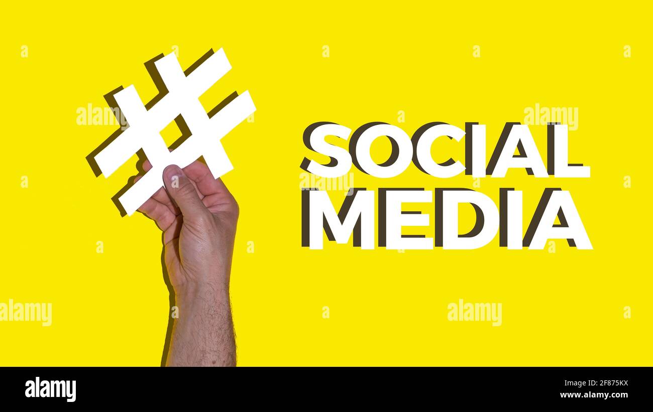 A man's hand holding a white hash on a yellow background with text ...