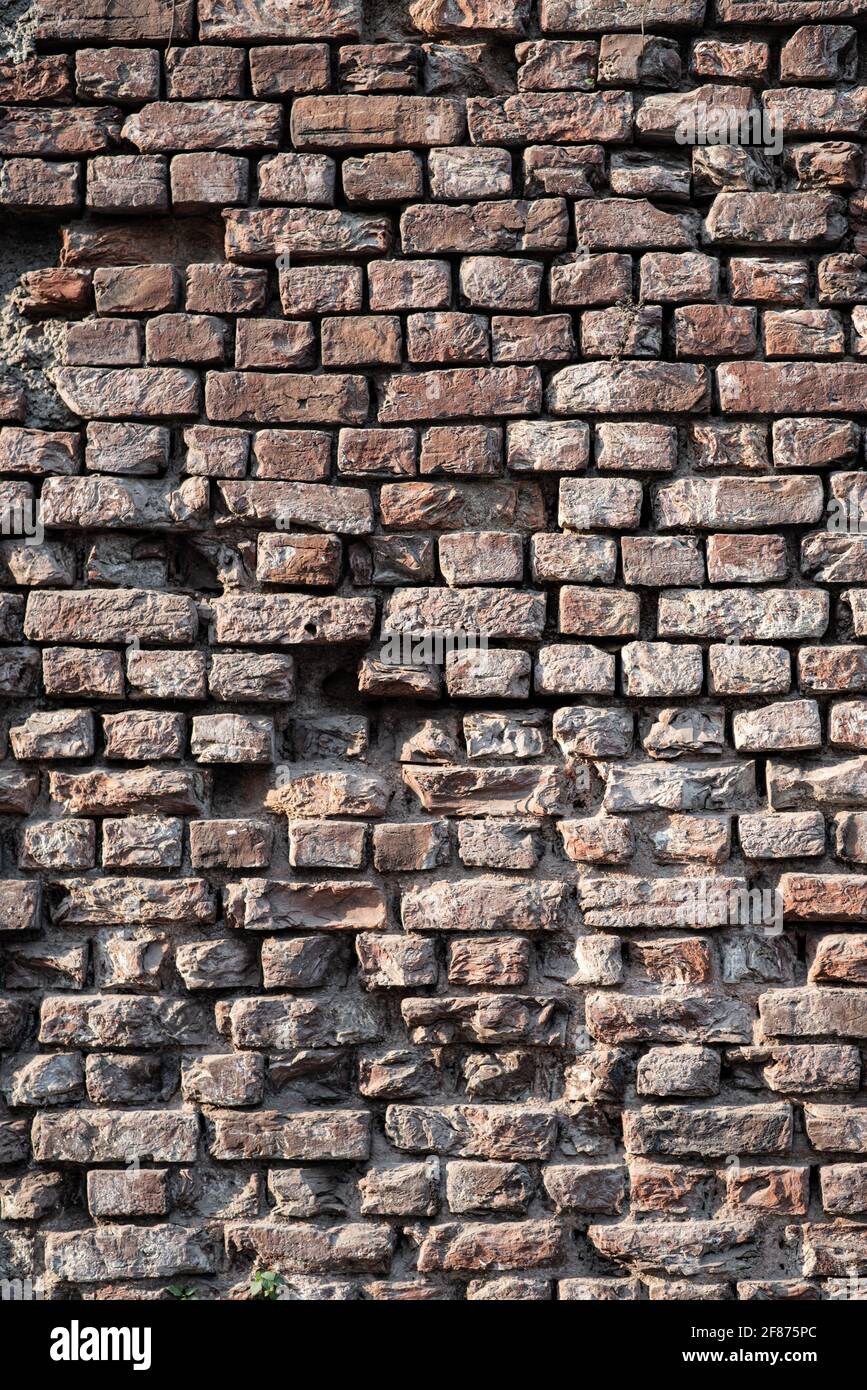 Vertical shot of an old weathered broken brick wall texture background Stock Photo - Alamy