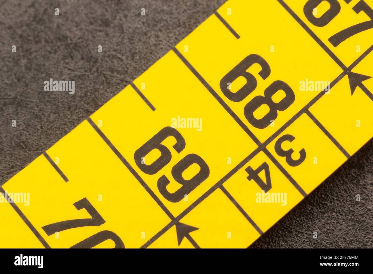 Portion of a tape measure, enlarged image of a centimeter on a color ...