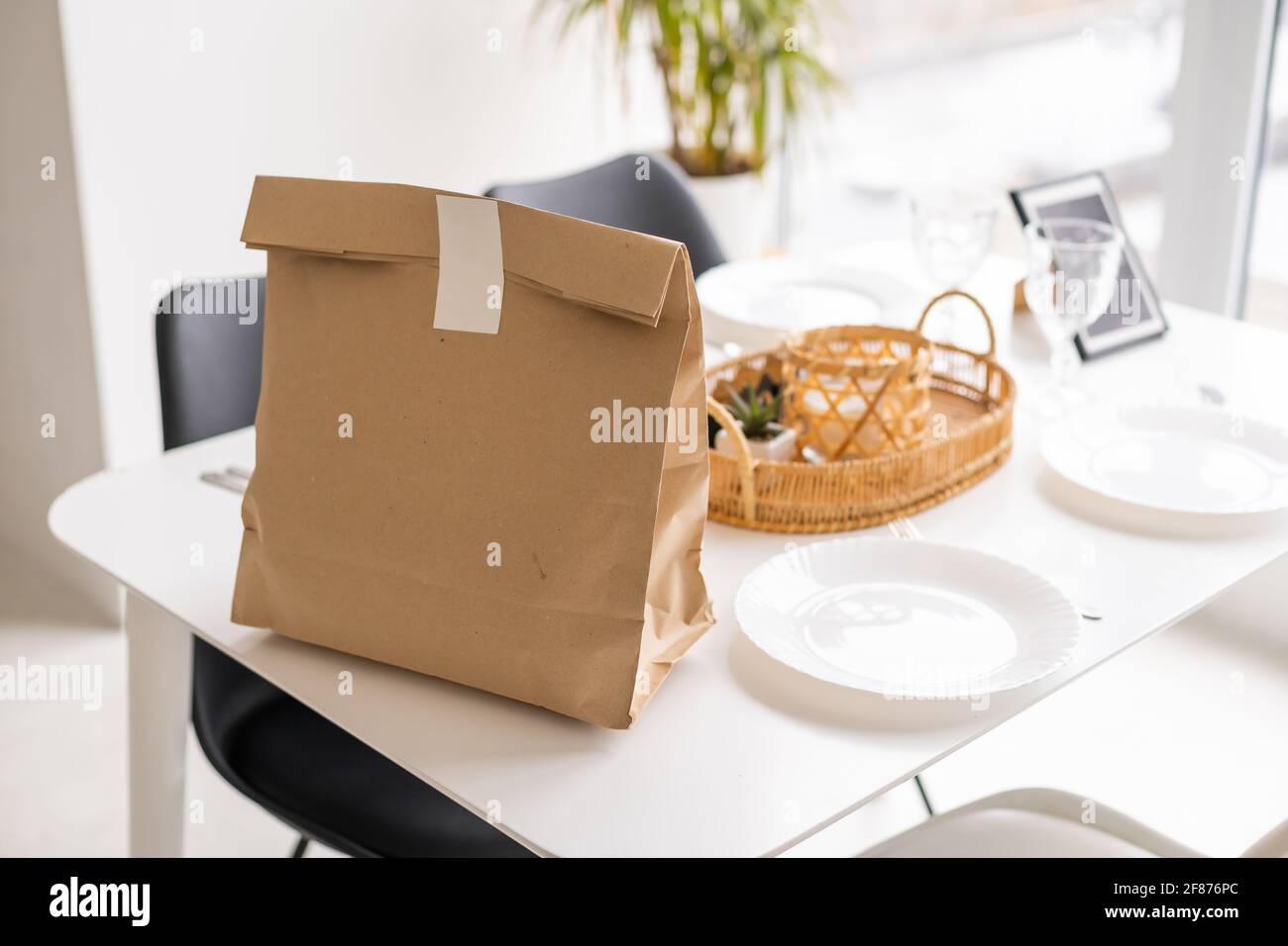 Paper packages with groceries on kitchen table Stock Photo - Alamy
