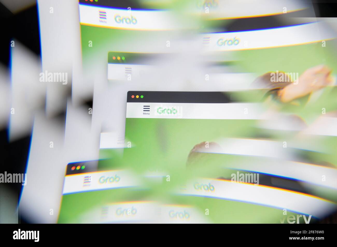Milan, Italy - APRIL 10, 2021: Grab logo on laptop screen seen through ...