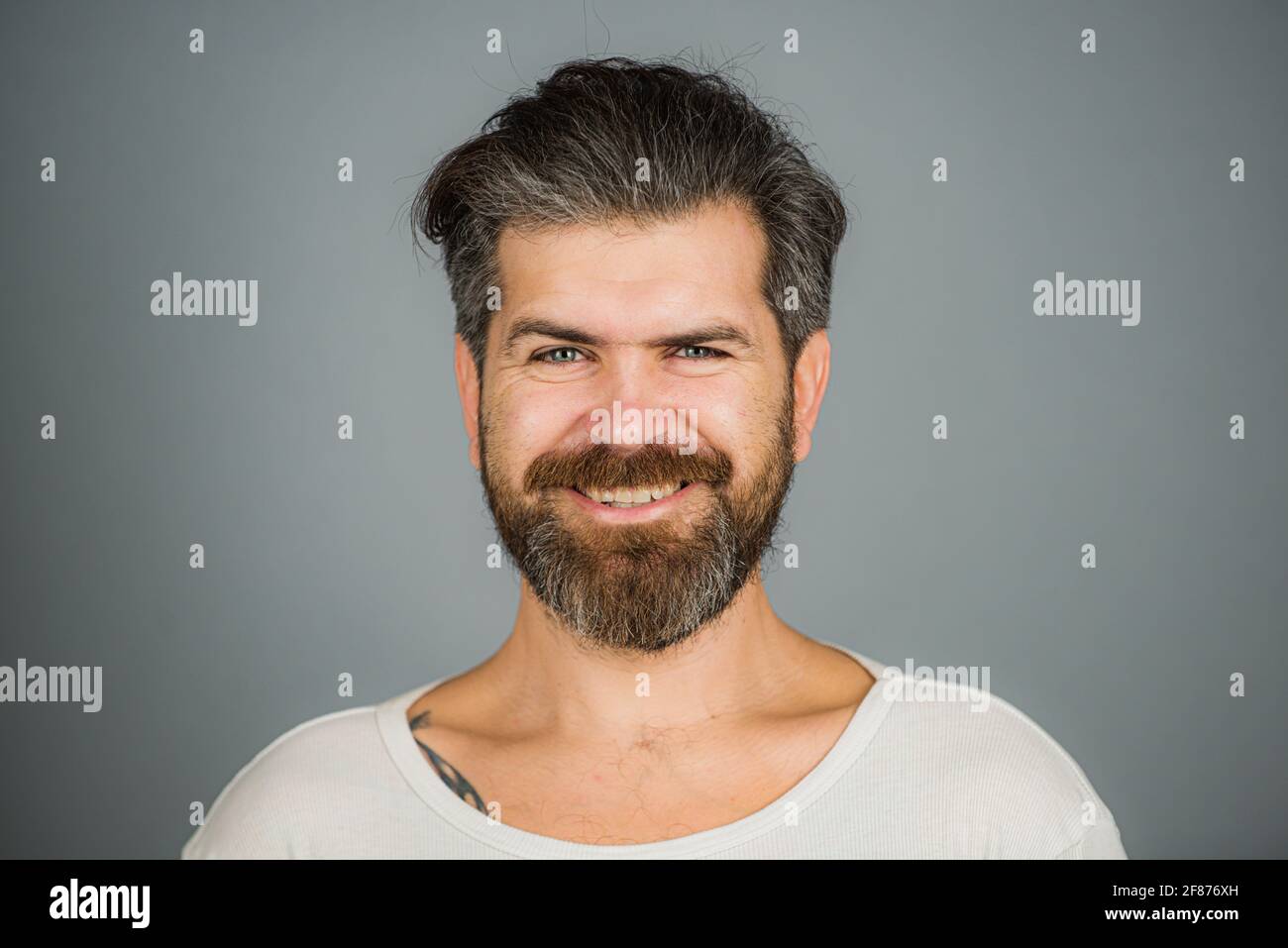 Bearded man smile face. Barbershop. Handsome smiling young guy. Human ...