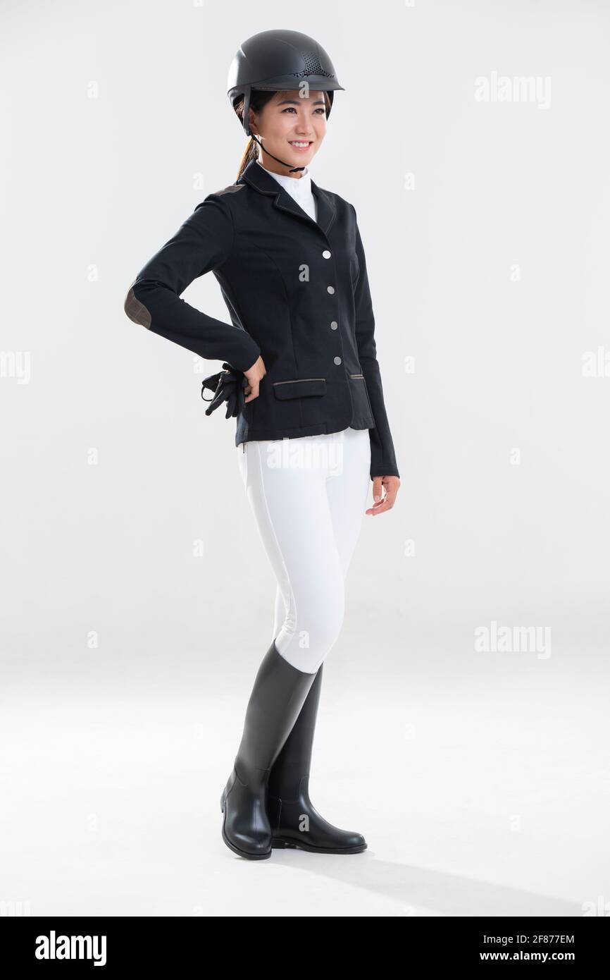 Happy young woman in riding clothes Stock Photo - Alamy