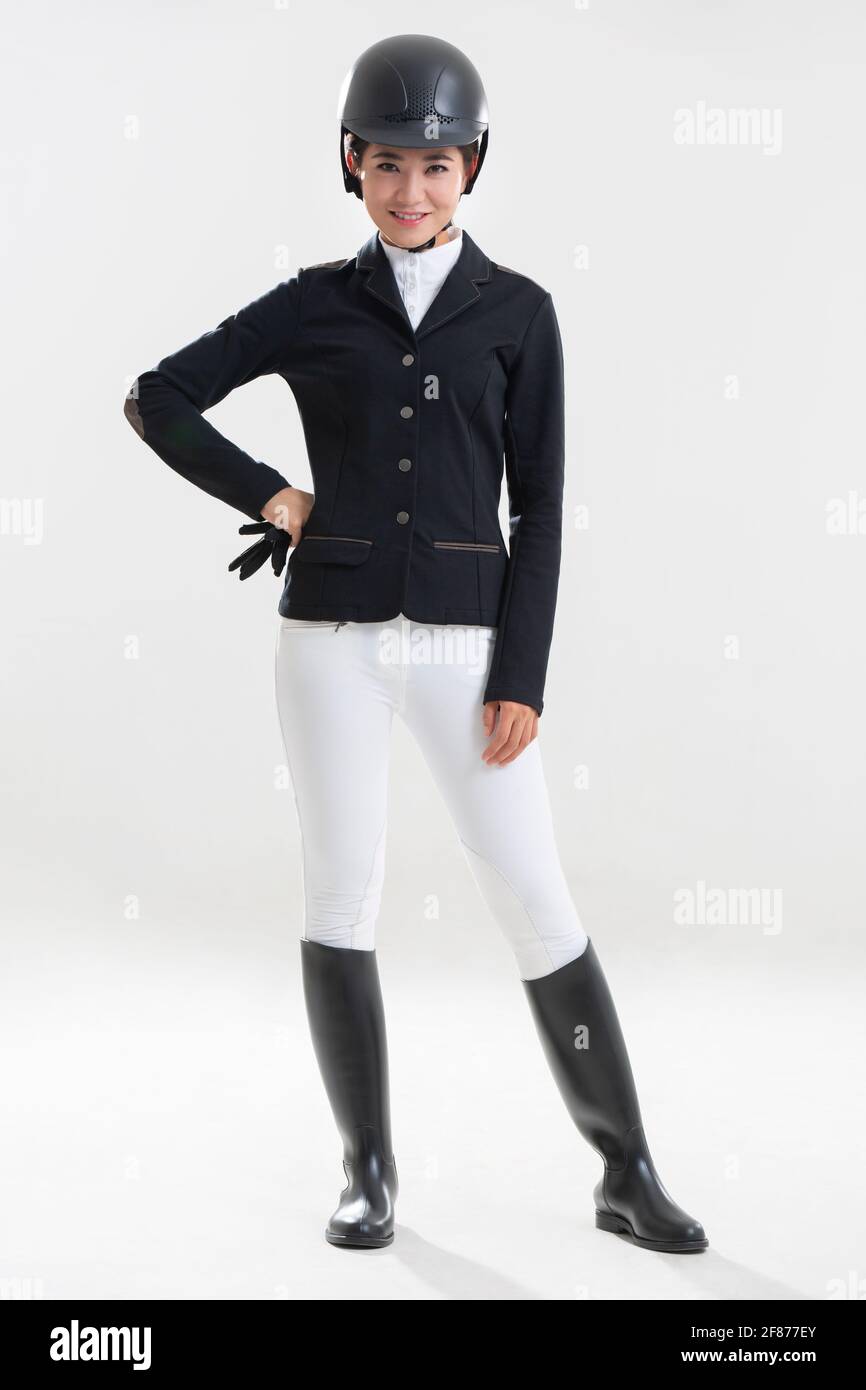 Happy young woman in riding clothes Stock Photo - Alamy
