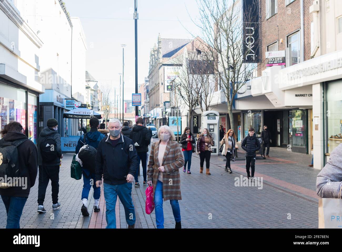 Middlesbrough, UK. April 12 2021: High street full of people following ...