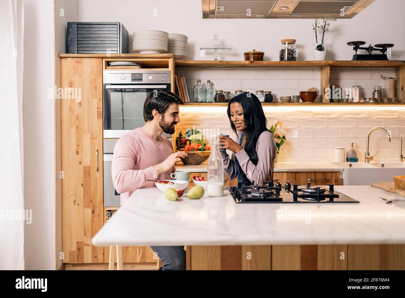 Cheerful black woman and her boyfriend having delicious breakfast in ...