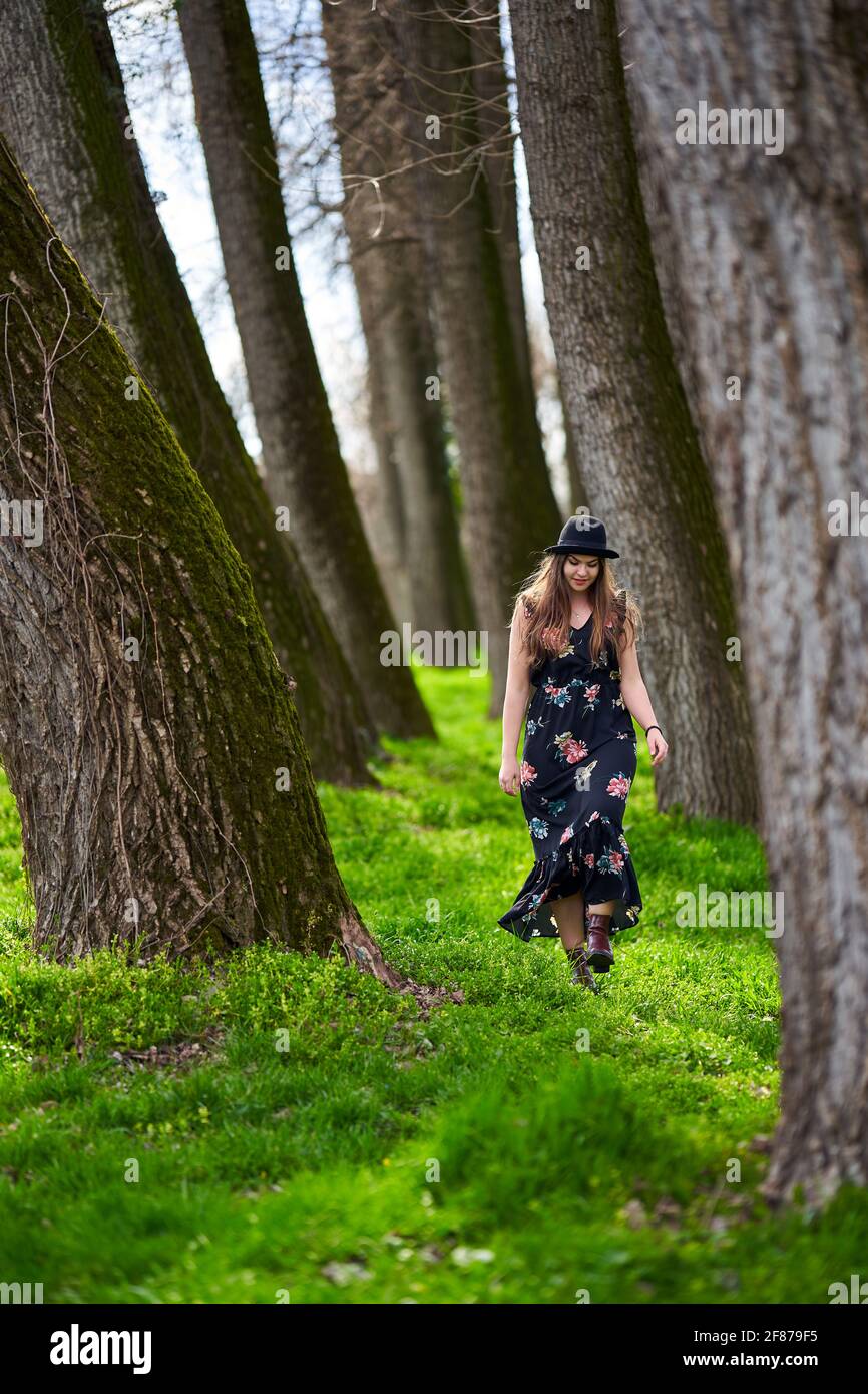 Young woman enjoying a stroll through the park in the early spring ...
